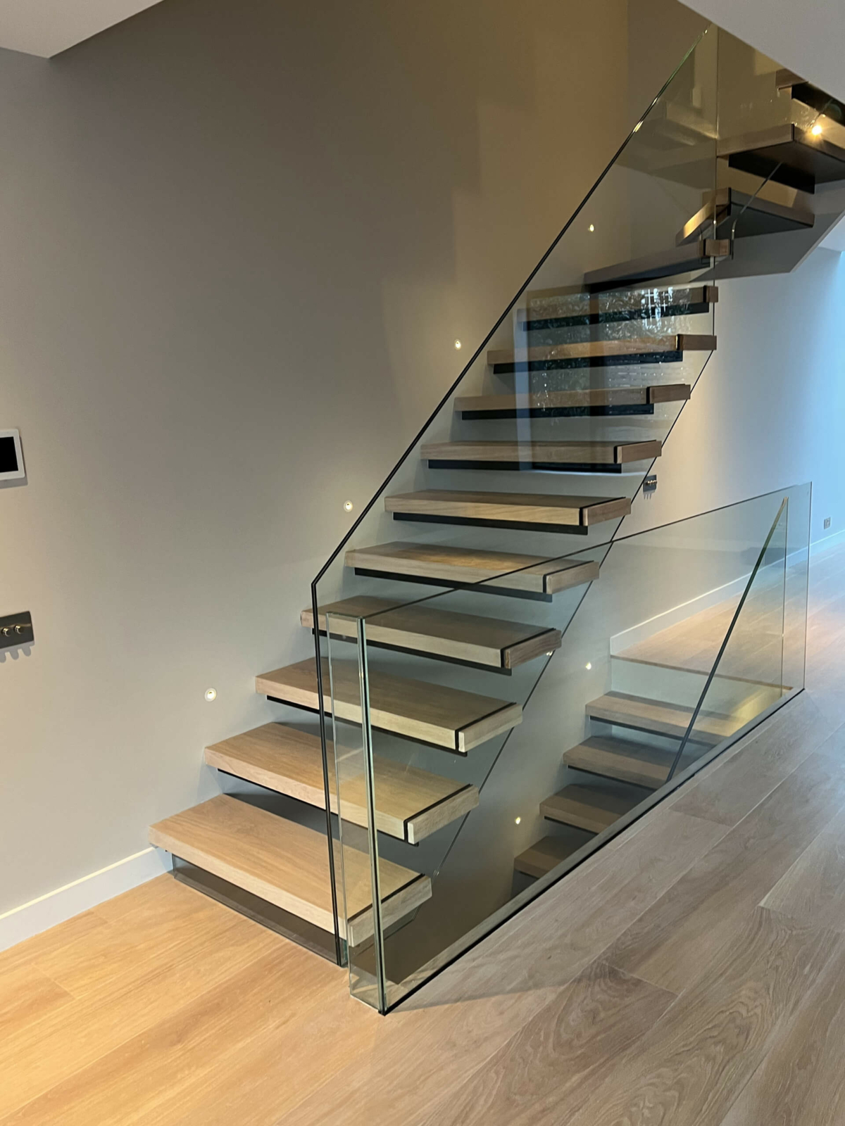 Floating Staircase with Frameless Glass Balustrade and Light Brown Oak ...